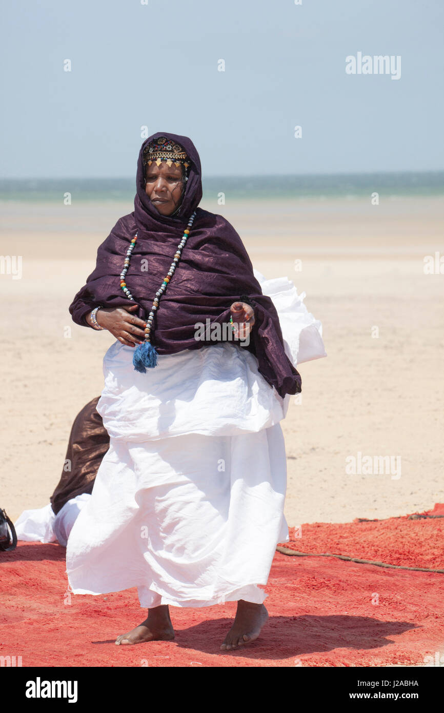 Africa, Western Sahara, Dakhla. Woman in tradition dress performing a ...