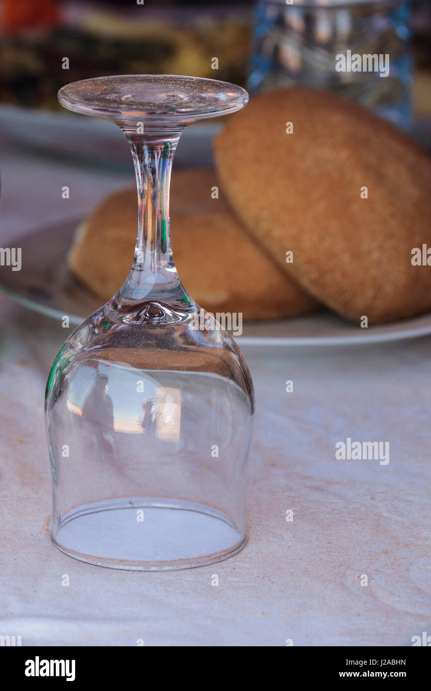 Africa, Western Sahara, Dakhla. Wine glass covered in sand blown in ...