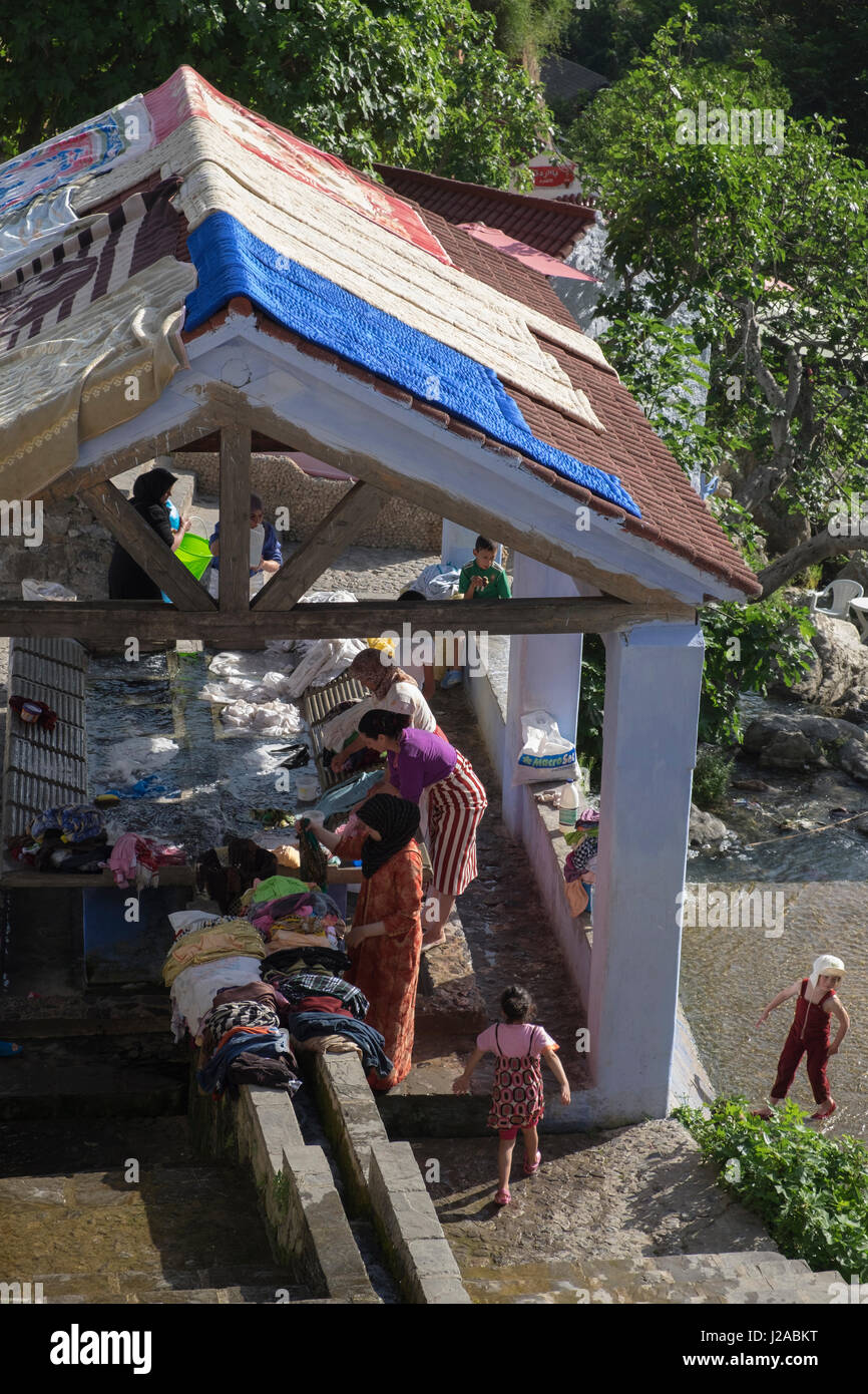 Morocco, Chefchaouen. Women washing clothes and carpets in a communal ...