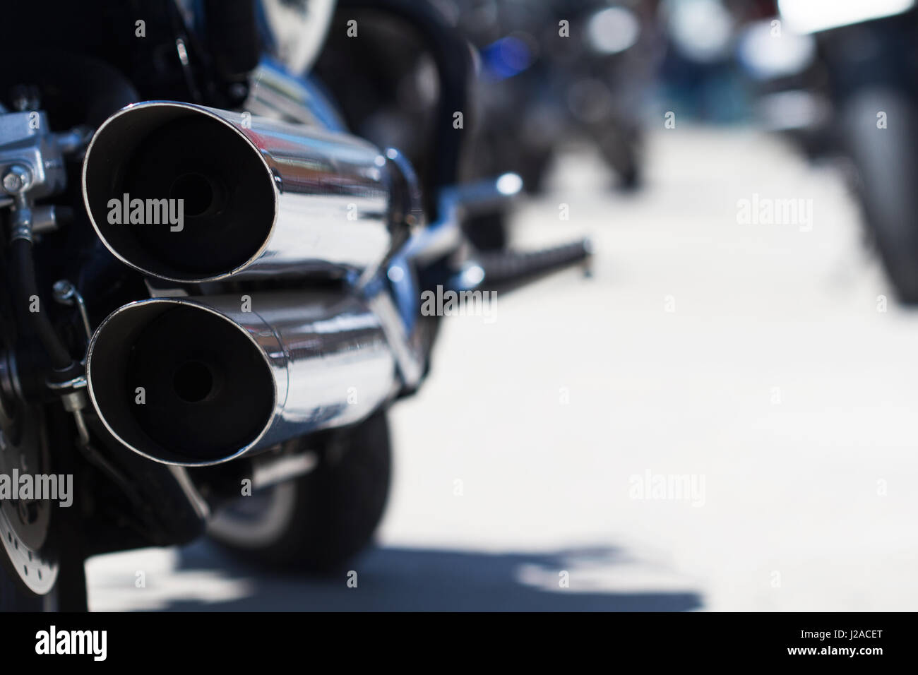 rear view of classical motorcycle pair of exhaust chrome pipes ...