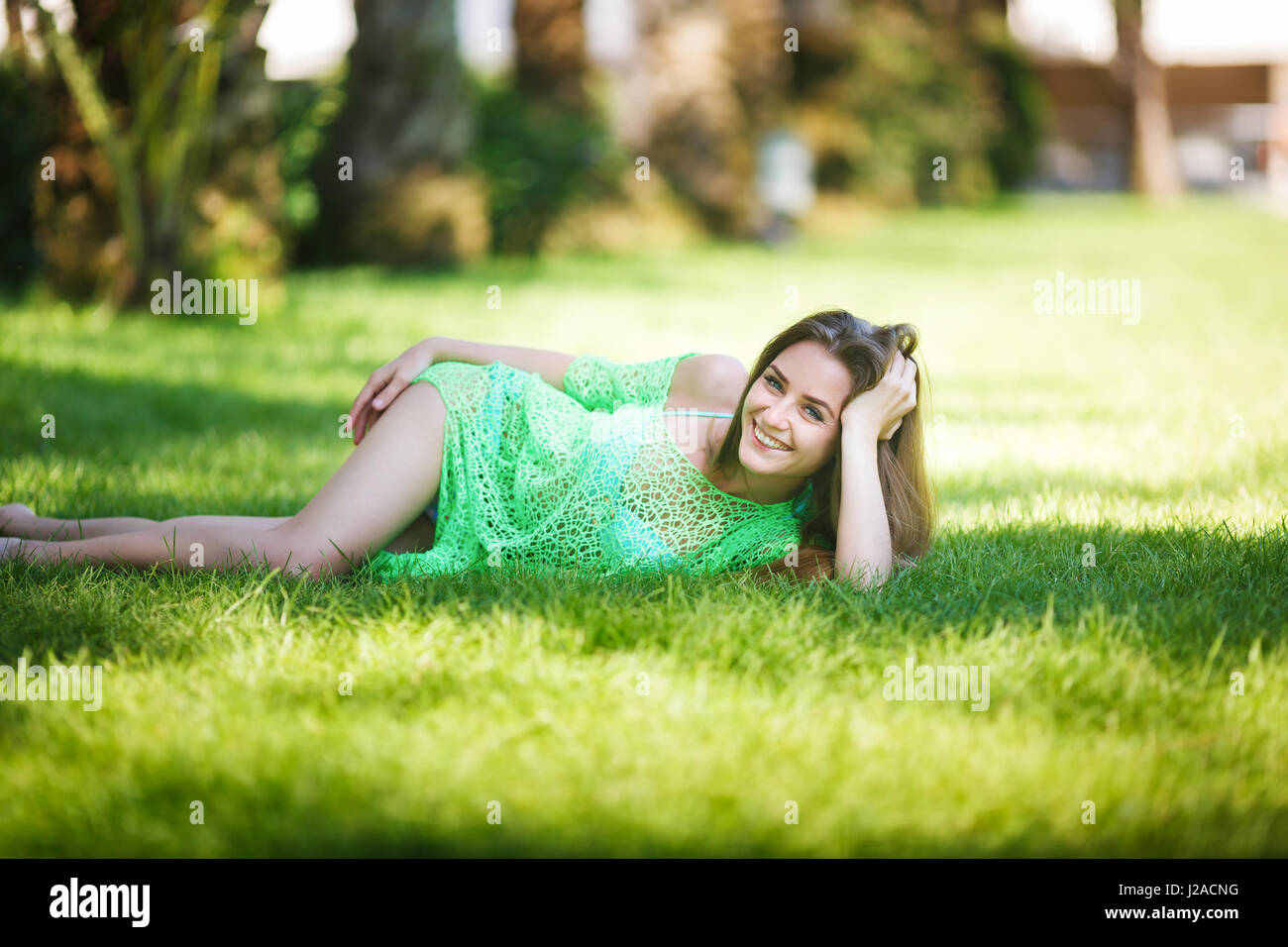 Female body lying in grass hi-res stock photography and images - Alamy