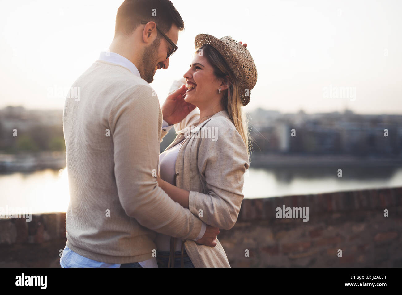Happy romantic couple in love hugging and smiling Stock Photo - Alamy