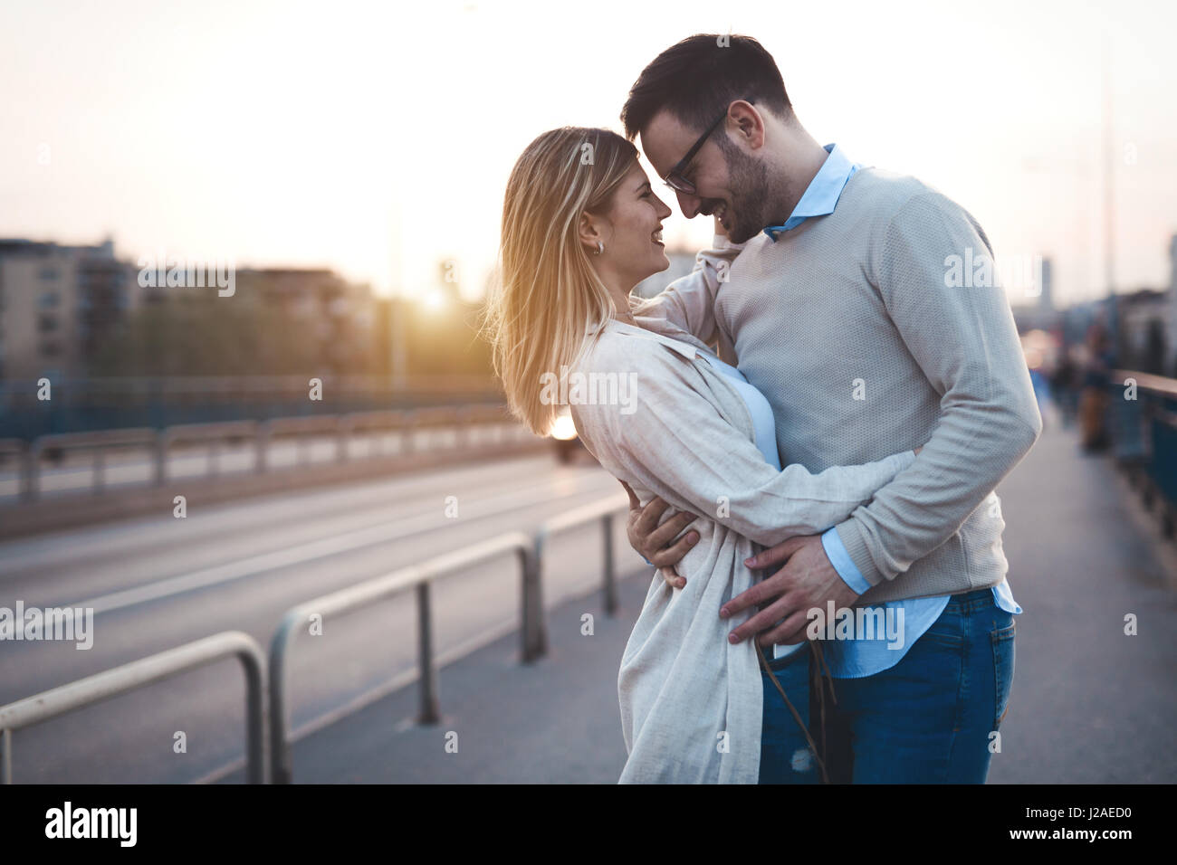 Happy romantic couple in love hugging and smiling Stock Photo - Alamy