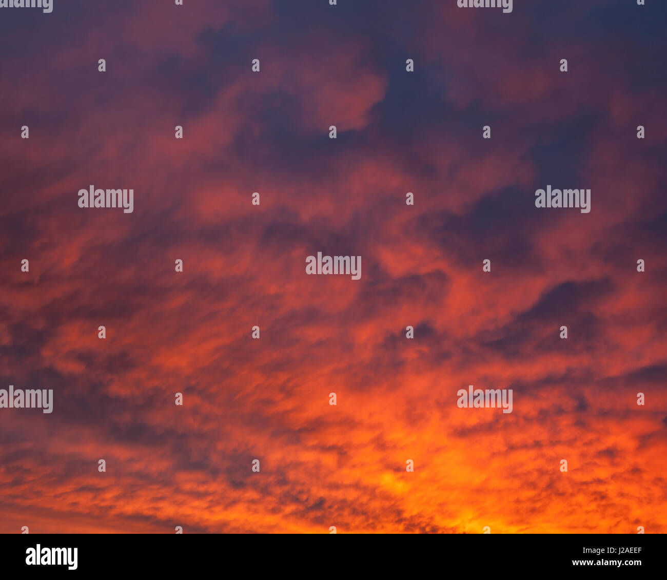 Fiery vivid sunset sky clouds Stock Photo - Alamy