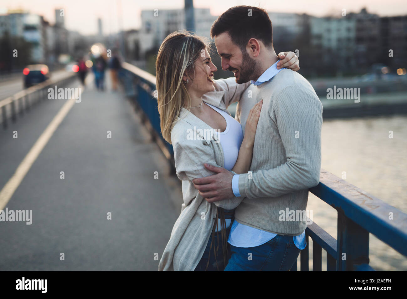 Happy romantic couple in love hugging and smiling Stock Photo - Alamy