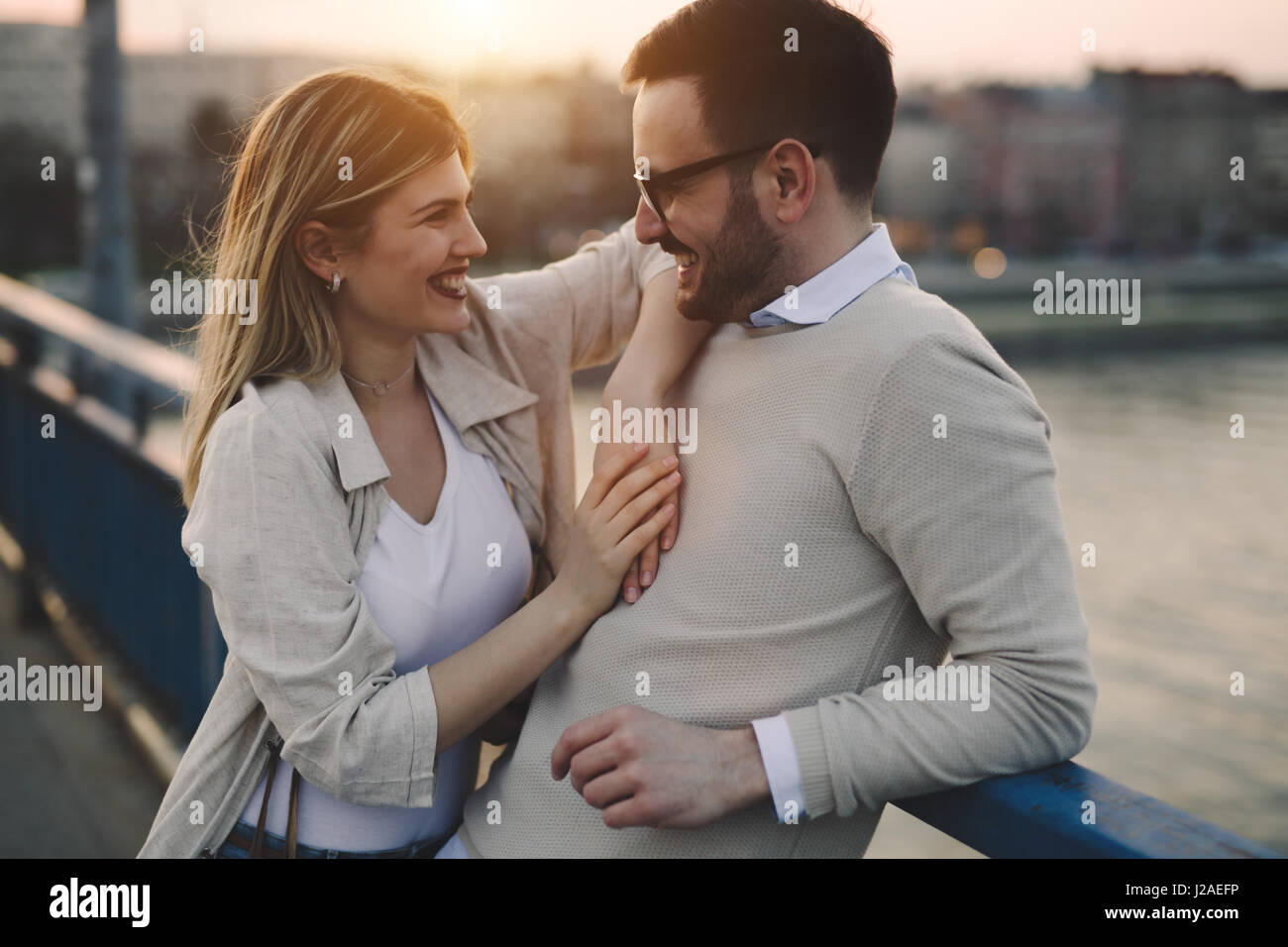 Happy romantic couple in love hugging and smiling Stock Photo - Alamy