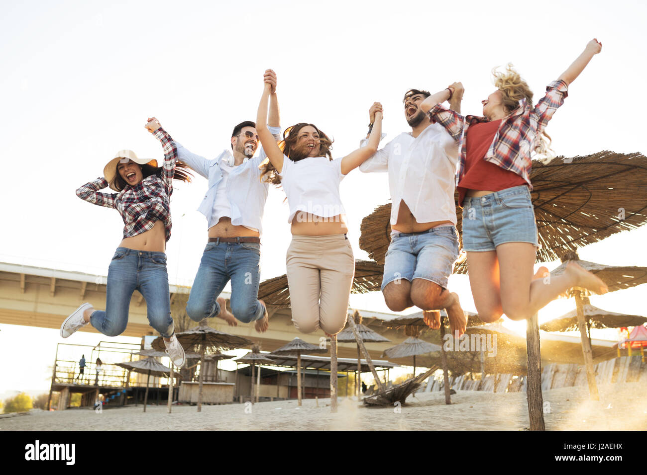 Group of happy young people enjoying summer vacation on beach Stock ...
