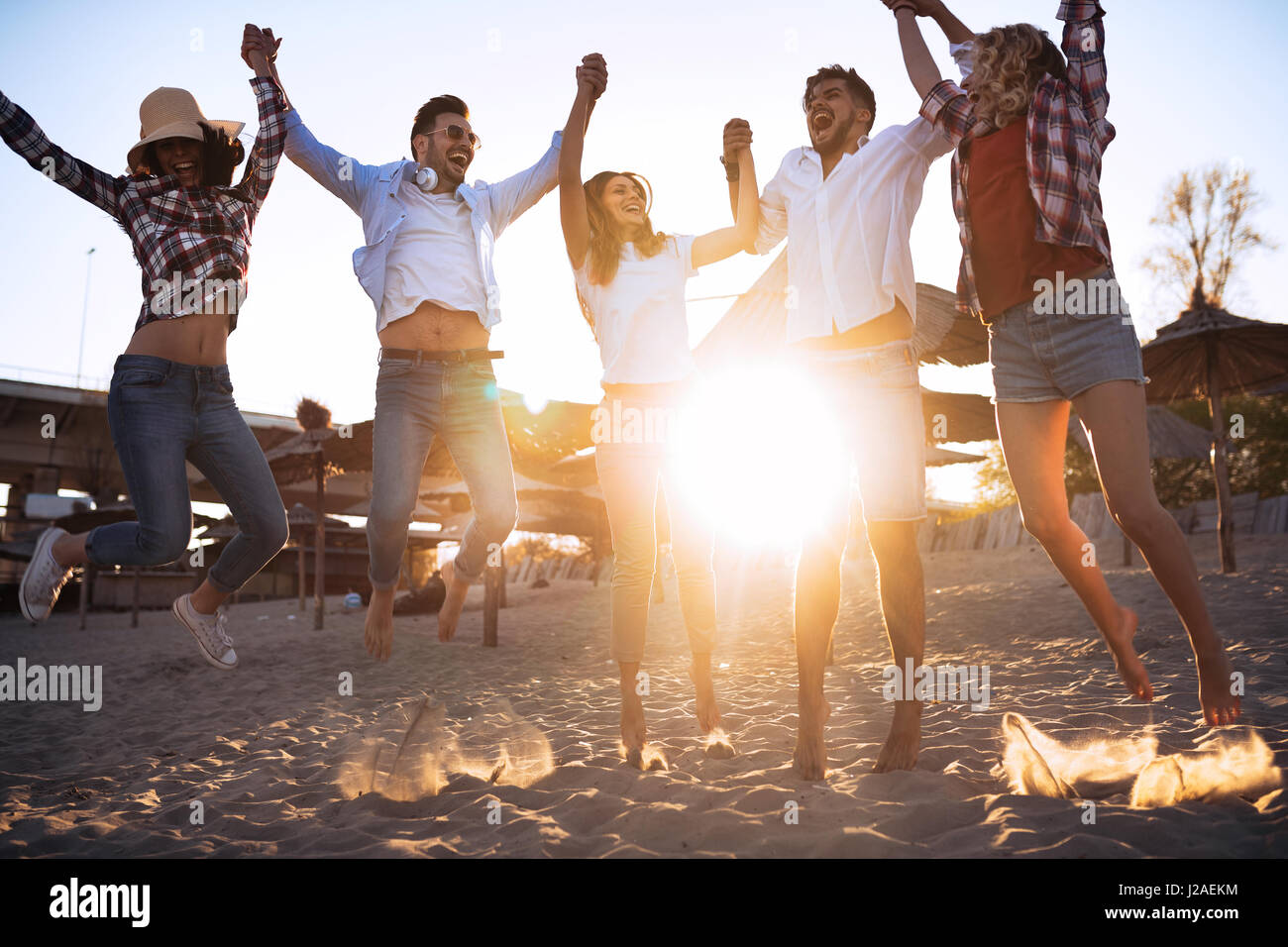 Group of happy young people enjoying summer vacation on beach Stock ...