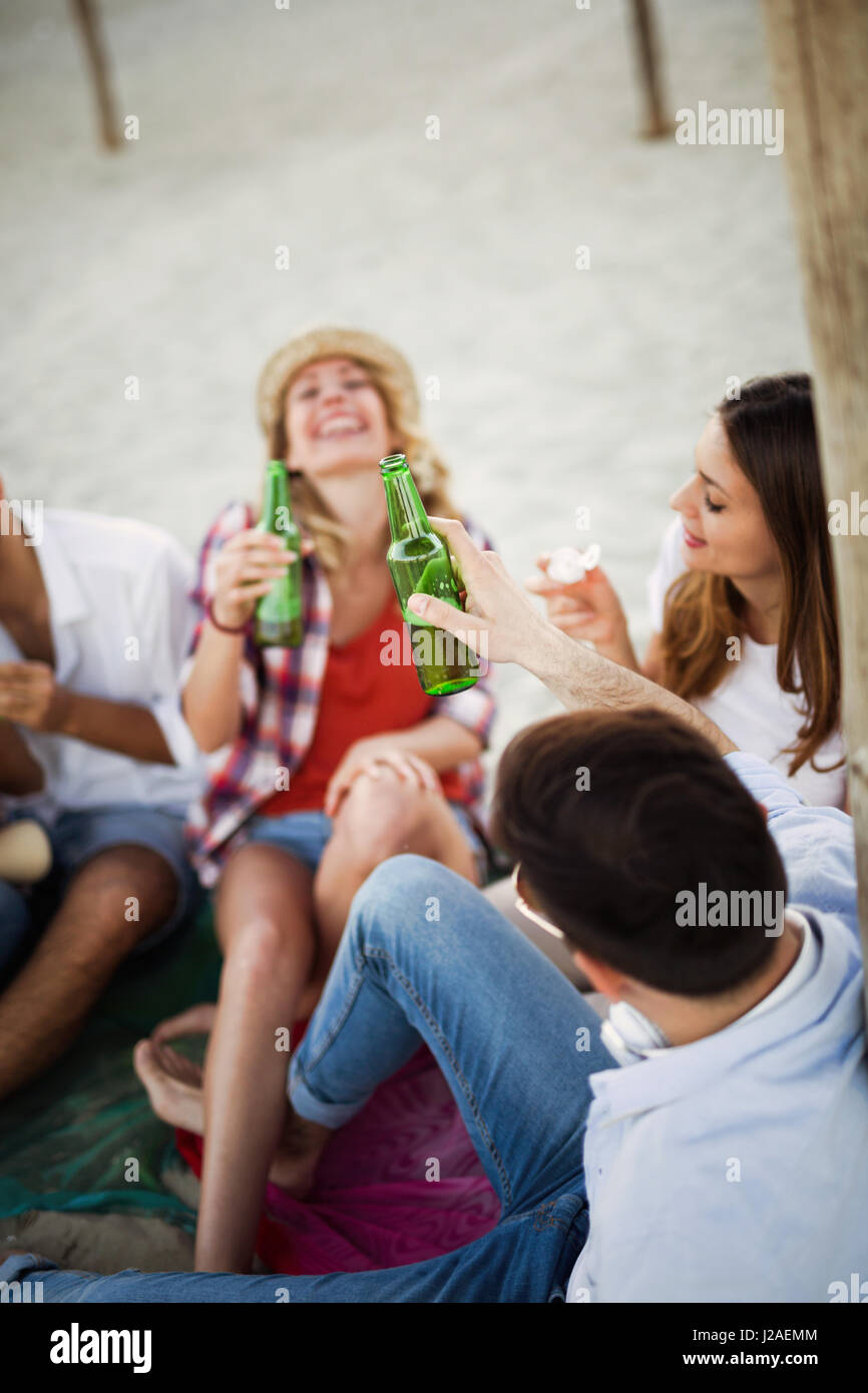 Happy people drinking and having fun at beach in summer Stock Photo - Alamy