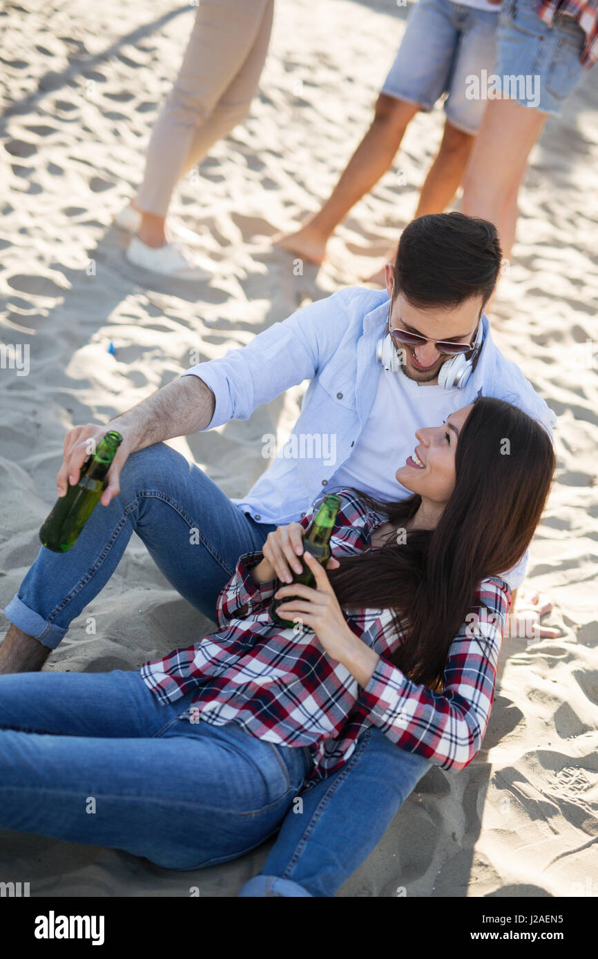 Happy people drinking and having fun at beach in summer Stock Photo - Alamy