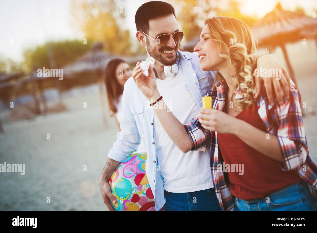 Group of happy friends partying on beach and having fun Stock Photo - Alamy