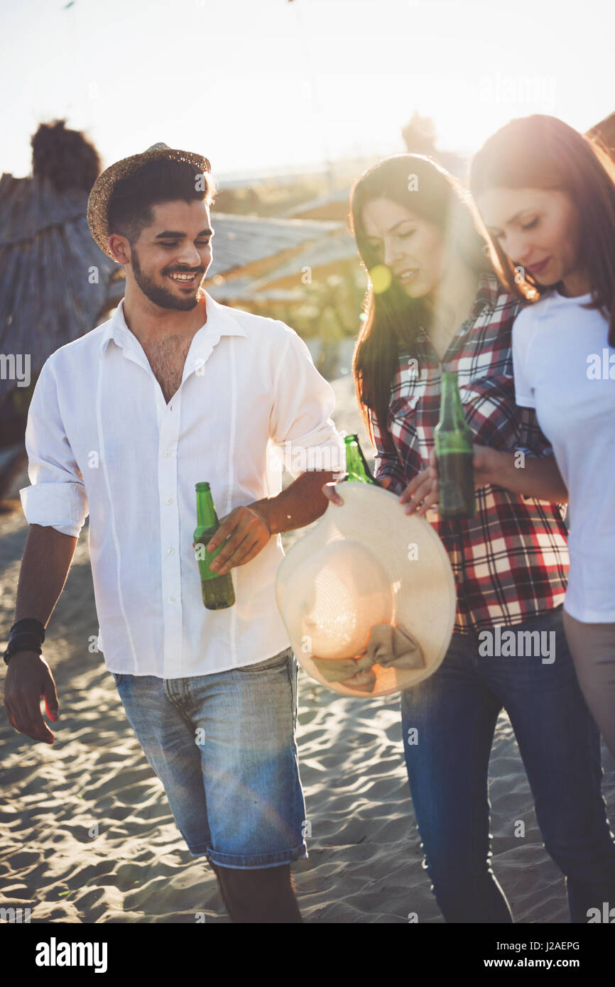 Happy people drinking and having fun at beach in summer Stock Photo - Alamy
