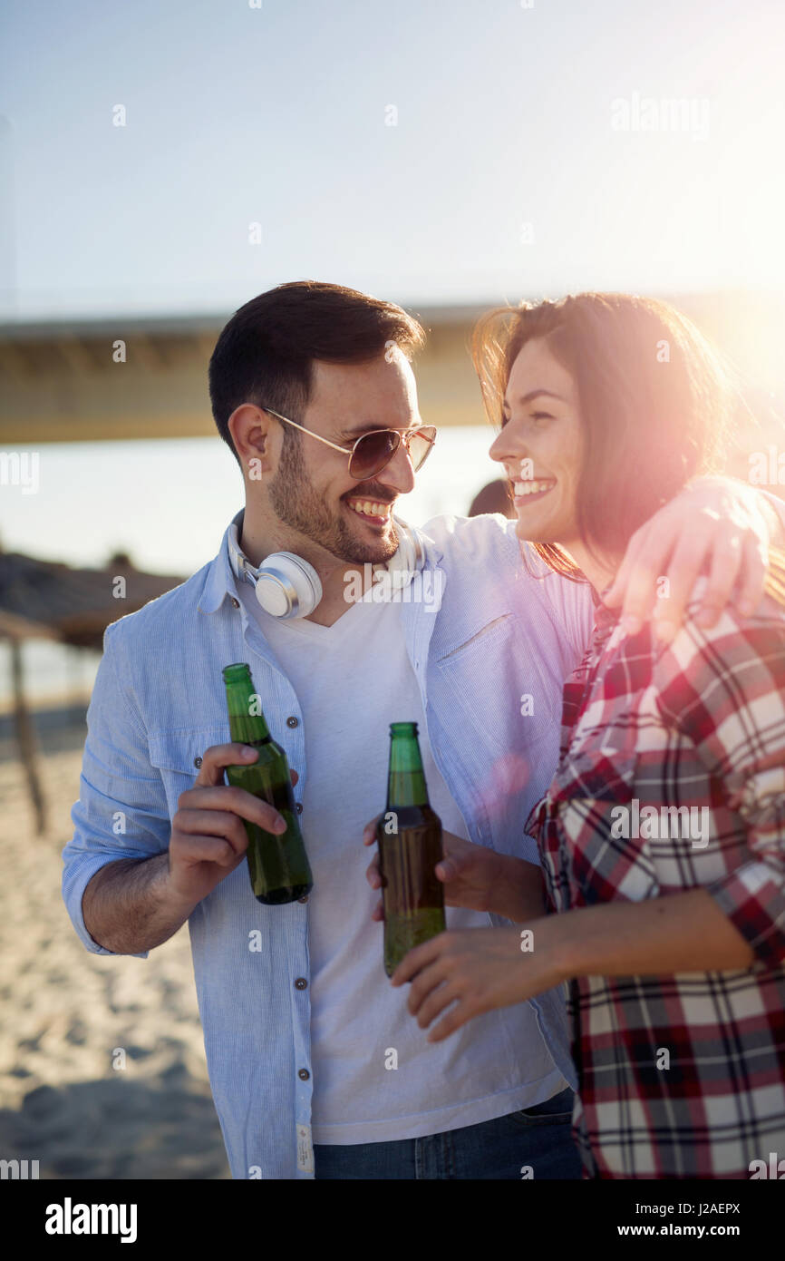 Happy people drinking and having fun at beach in summer Stock Photo - Alamy
