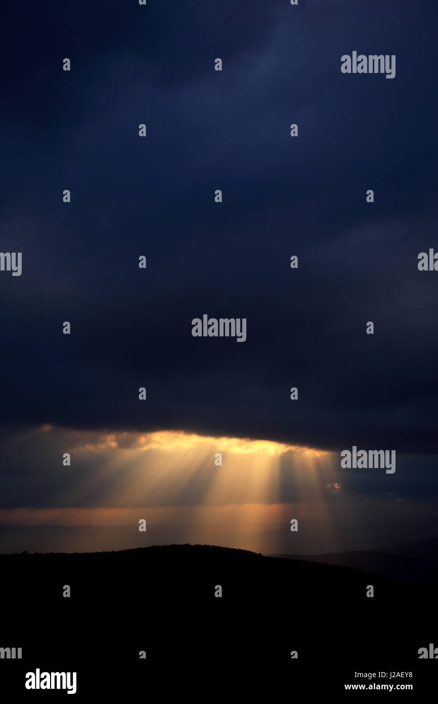 Ray of sun between the stormy sky Stock Photo - Alamy