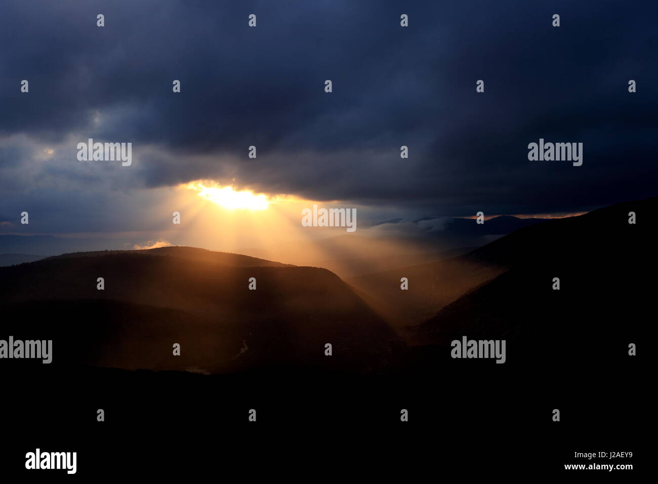 Ray of sun between the stormy sky Stock Photo - Alamy