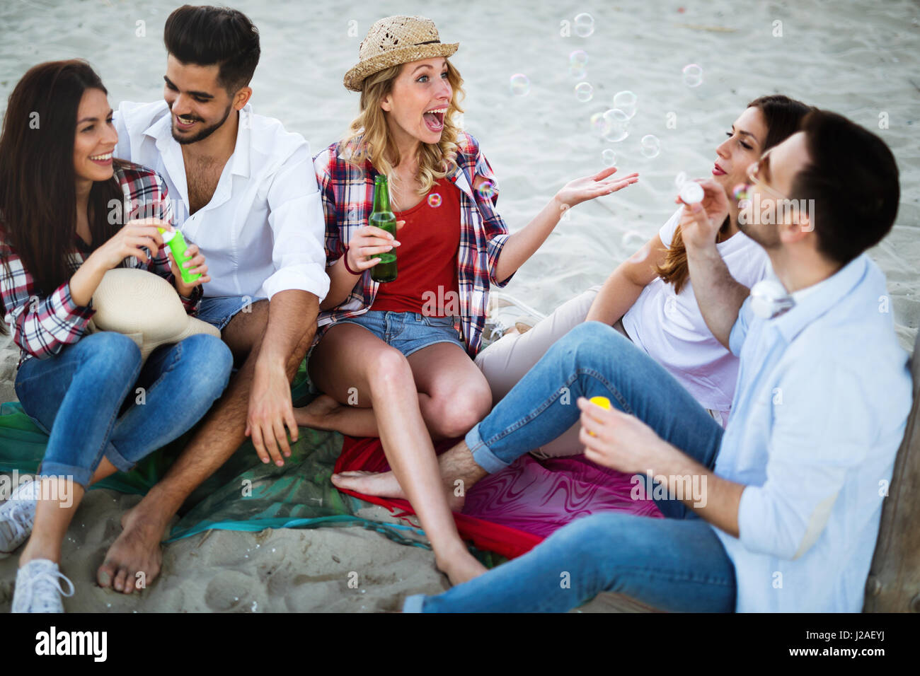Happy people drinking and having fun at beach in summer Stock Photo - Alamy