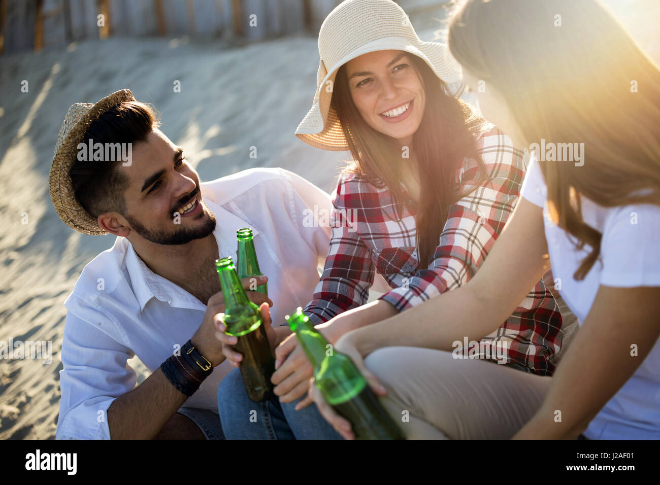 Group of happy friends partying on beach and having fun Stock Photo - Alamy