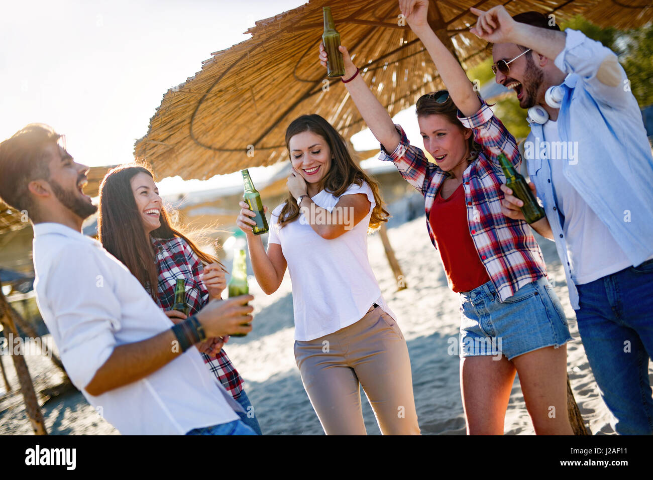 Happy friends partying and having fun on beach at summer Stock Photo ...