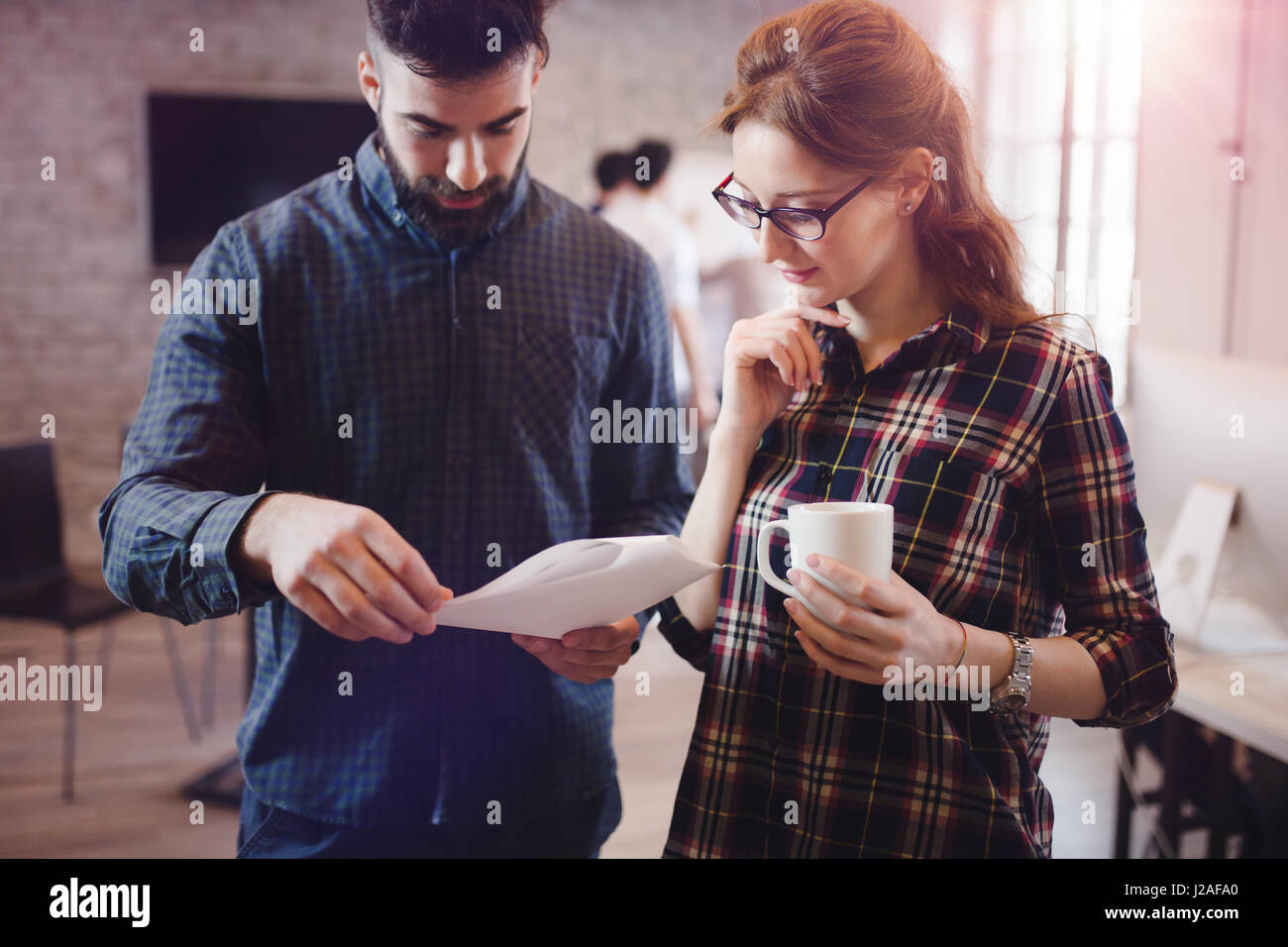 Coworking colleagues having conversation at workplace and sharing ideas ...