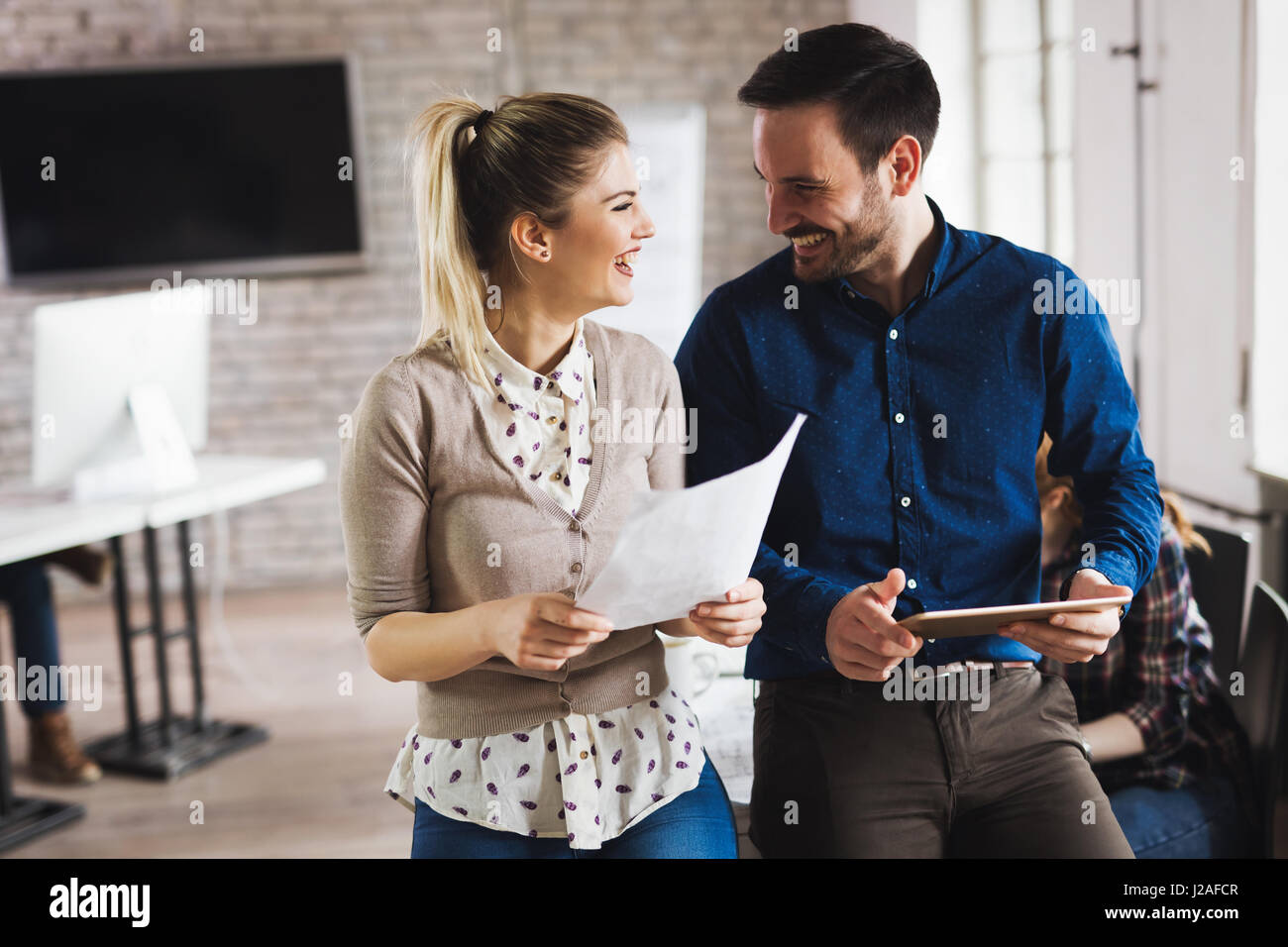 Coworking colleagues having conversation at workplace and sharing ideas ...