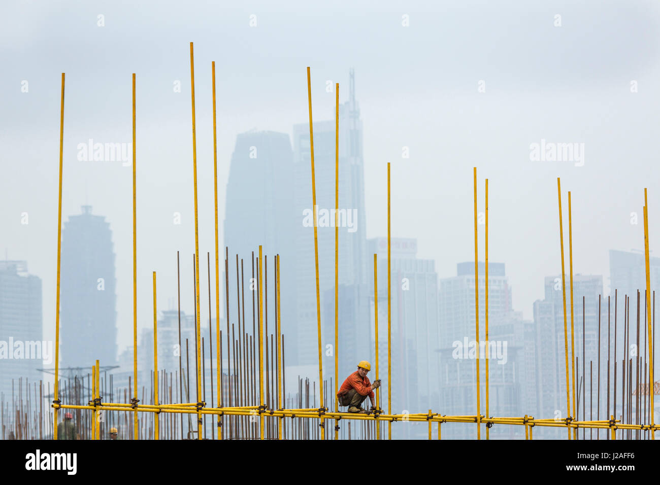 China, Chongqing, Steel worker assembles massive scaffolding at ...