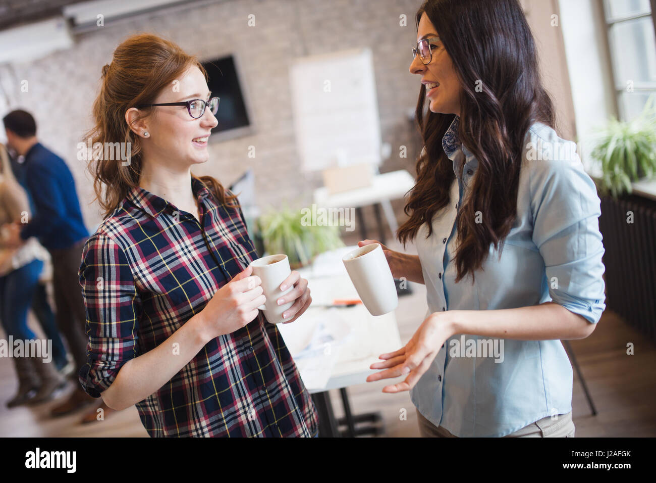 Female employees having coffee break in modern office Stock Photo - Alamy