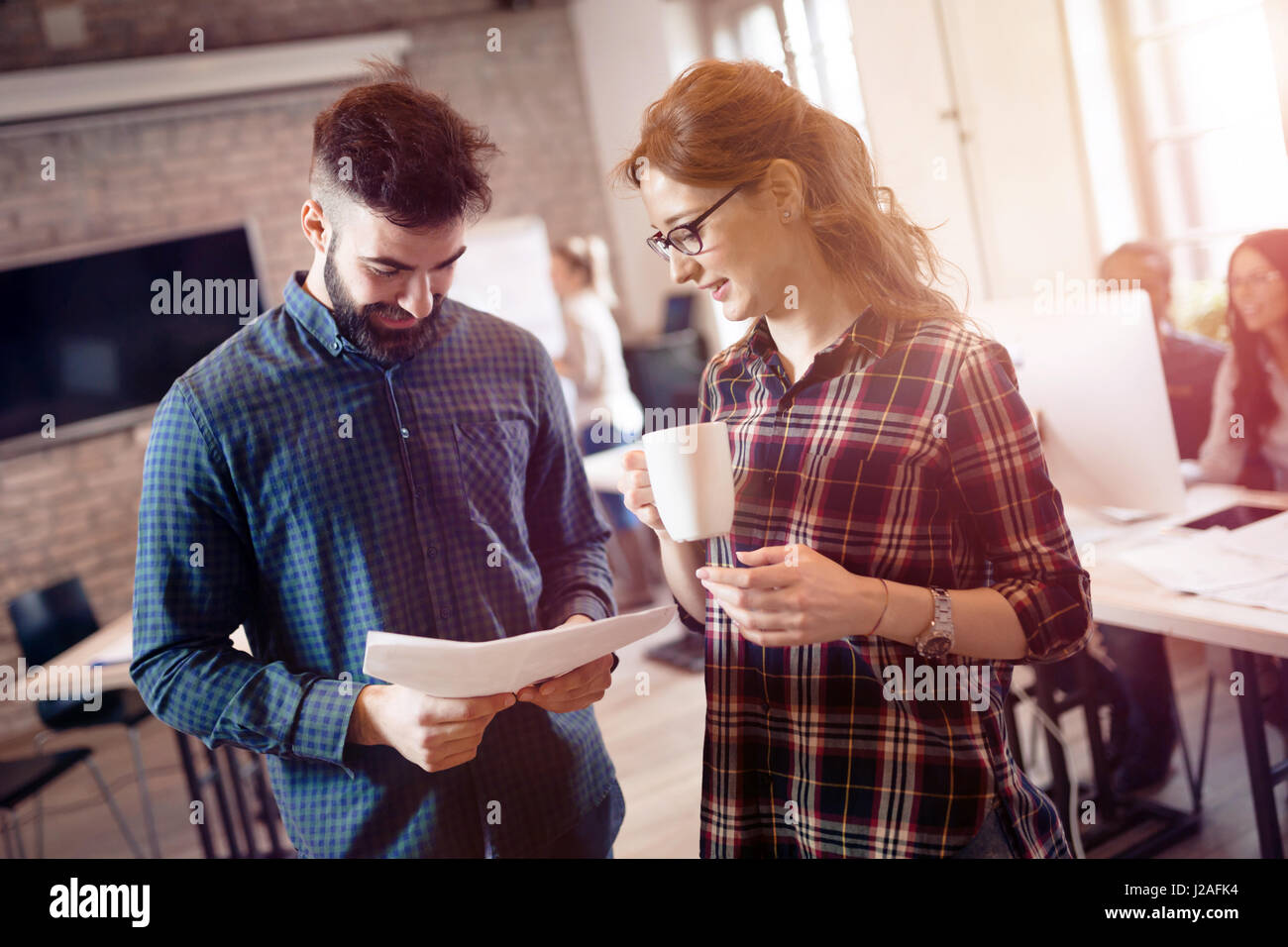 Coworking colleagues having conversation at workplace and sharing ideas ...