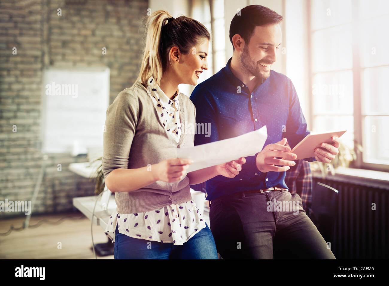 Coworking colleagues having conversation at workplace and sharing ideas ...