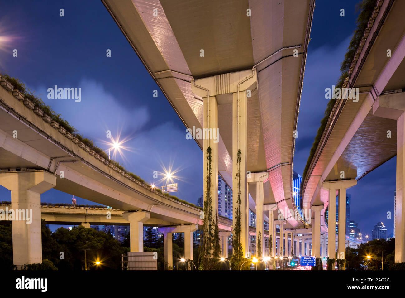 China, Shanghai, Towering overpass of Yan'an Expressway with city ...