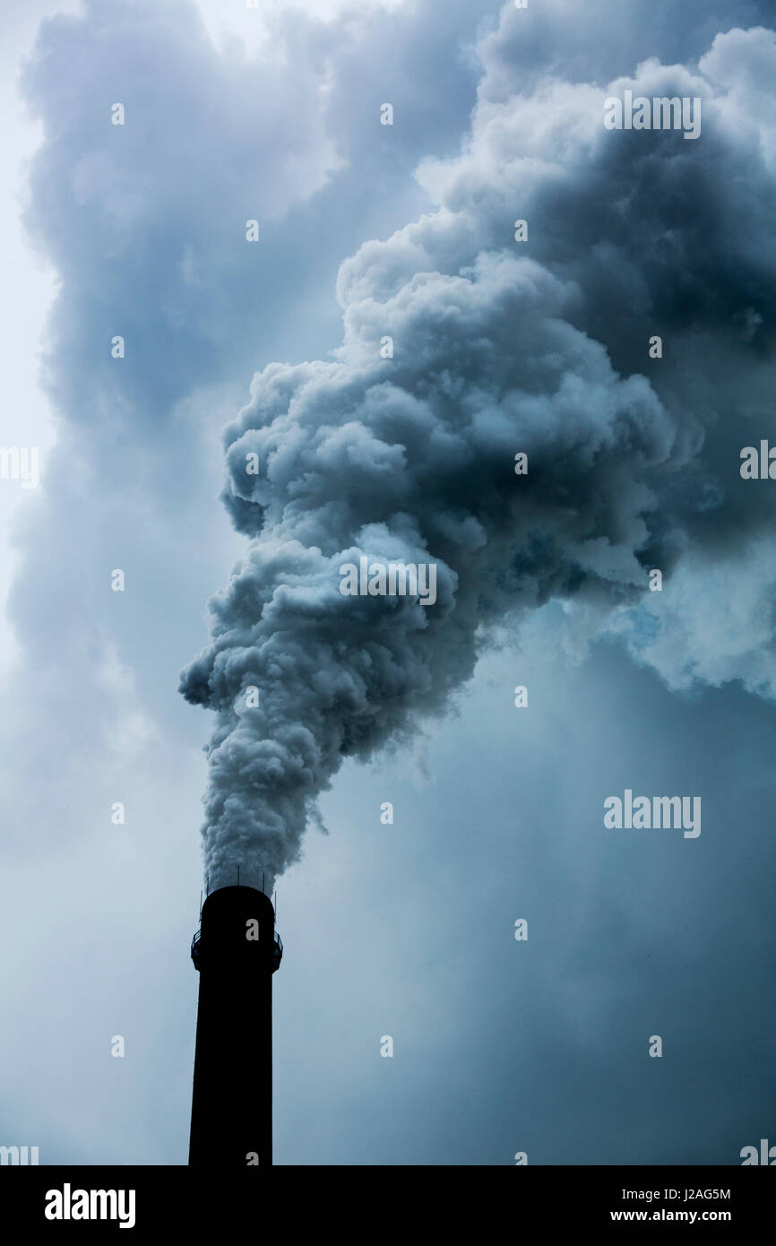China, Chongqing, Steam and smoke billows from smokestacks at massive ...