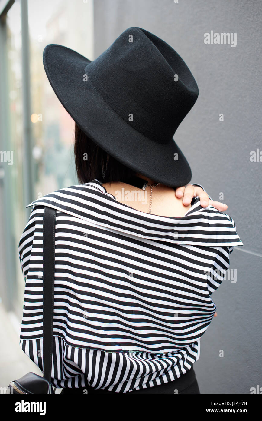 Woman in hat and striped shirt, back view Stock Photo - Alamy