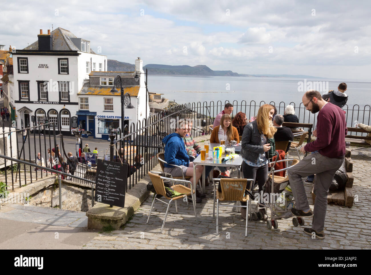 Lyme Regis town centre, Lyme Regis, Dorset England UK - People sitting ...