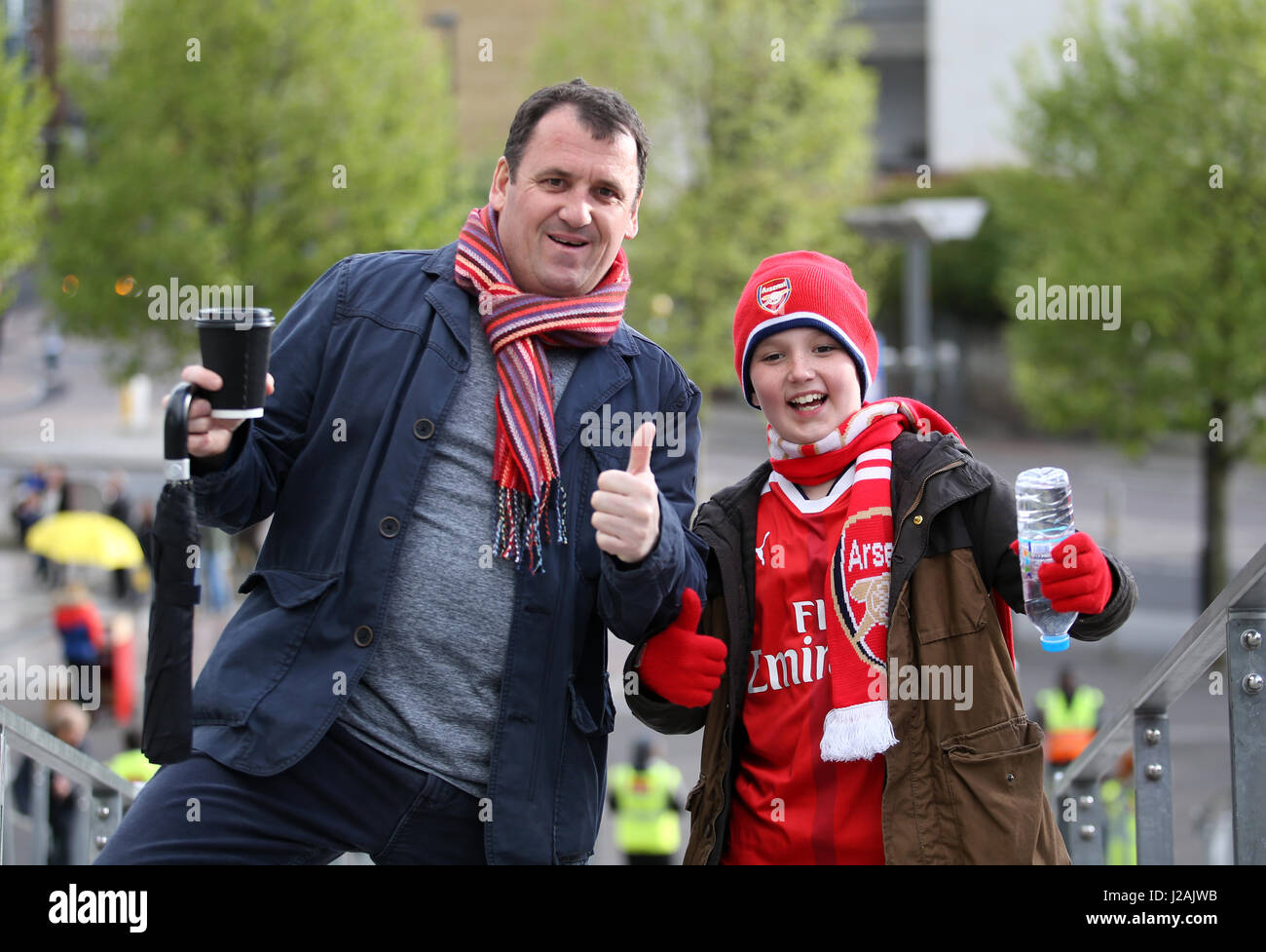 Arsenal fans give a thumbs up outside the Emirates stadium during the ...