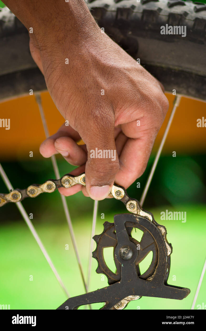 Closeup hand working on mechanical parts next to wheel spokes Stock ...
