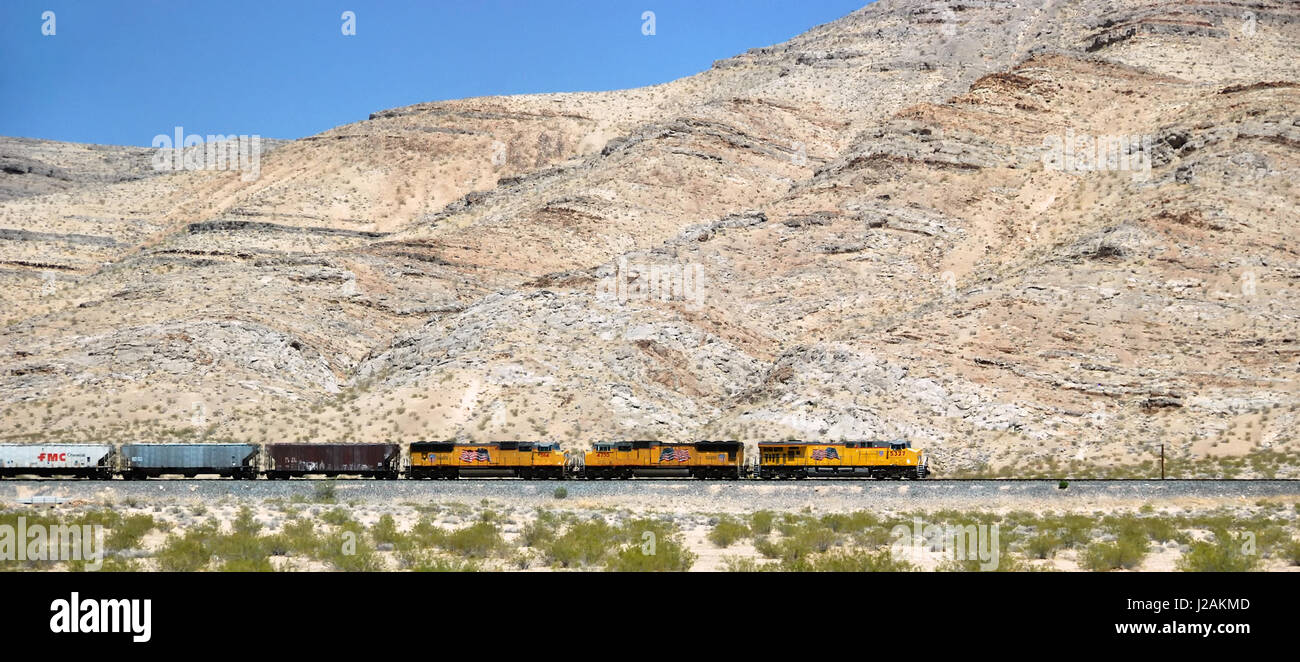 Union Pacific powered freight train passing mountains in Nevada, USA ...