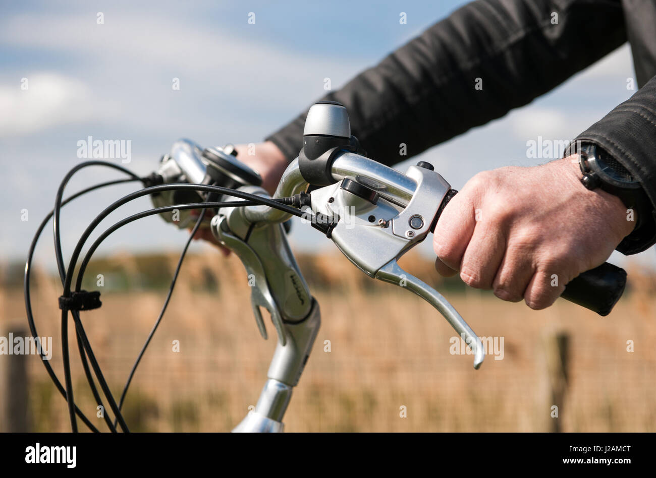 Close up of a cyclist holding his steering wheel Stock Photo - Alamy