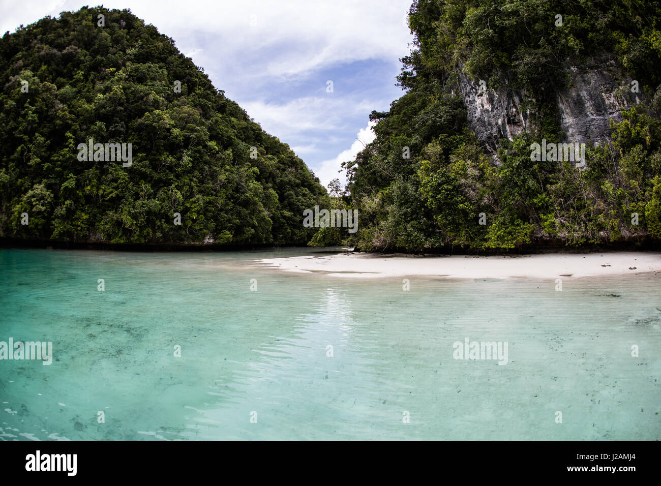 Limestone islands surround a small beach and shallow lagoon in the ...