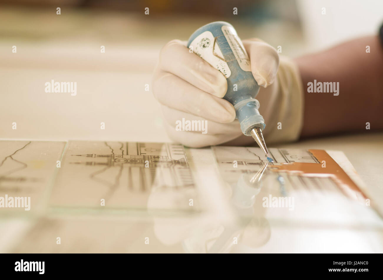 Closeup handcraft workers hand using painting tool for glass applying ...