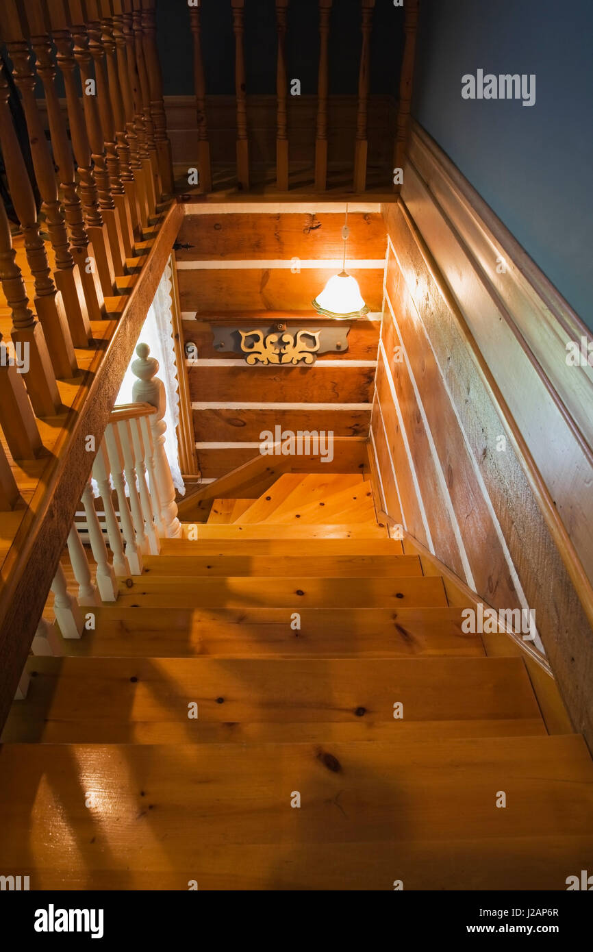 Wooden staircase leading to the downstairs floor inside a stacked log ...