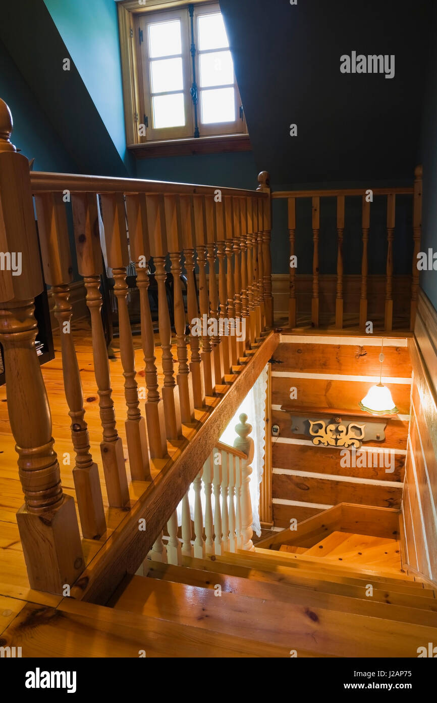 Wooden staircase leading to the downstairs floor inside a stacked log ...