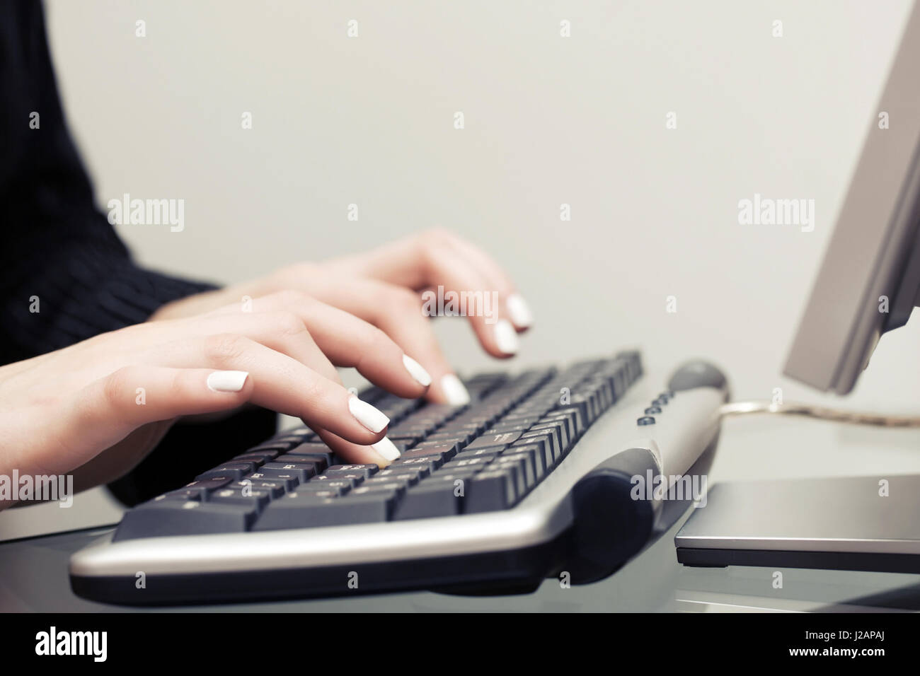 Woman typing on computer keyboard Stock Photo - Alamy