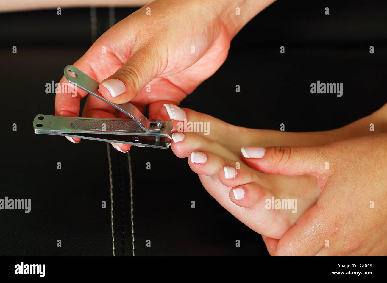 Nail clipping, cutting skins pedicure treatment Stock Photo - Alamy