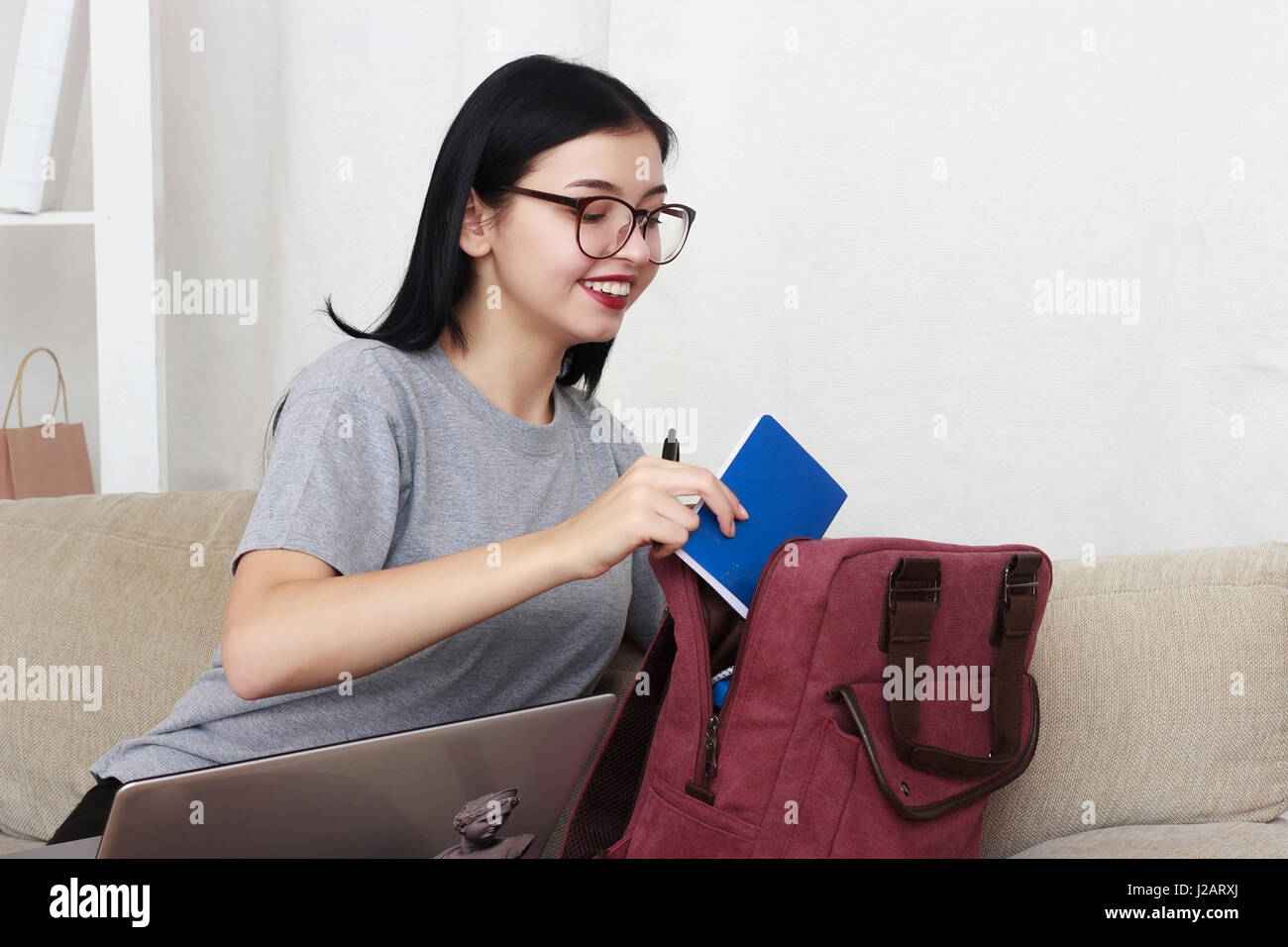 Female student taking notebooks out of her bag Stock Photo - Alamy