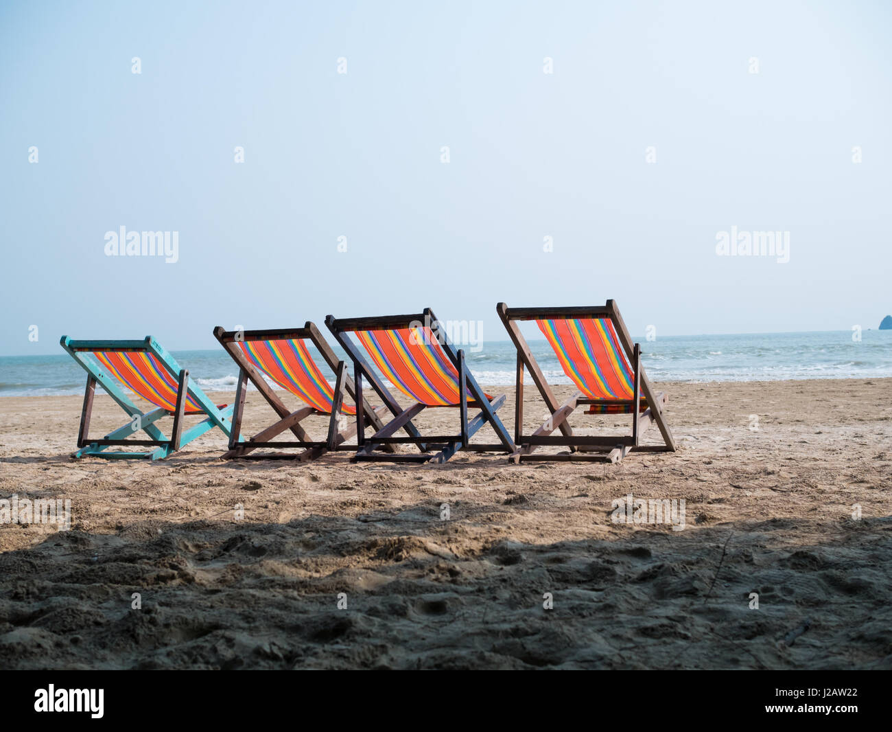 Four deck chairs on beach Stock Photo - Alamy
