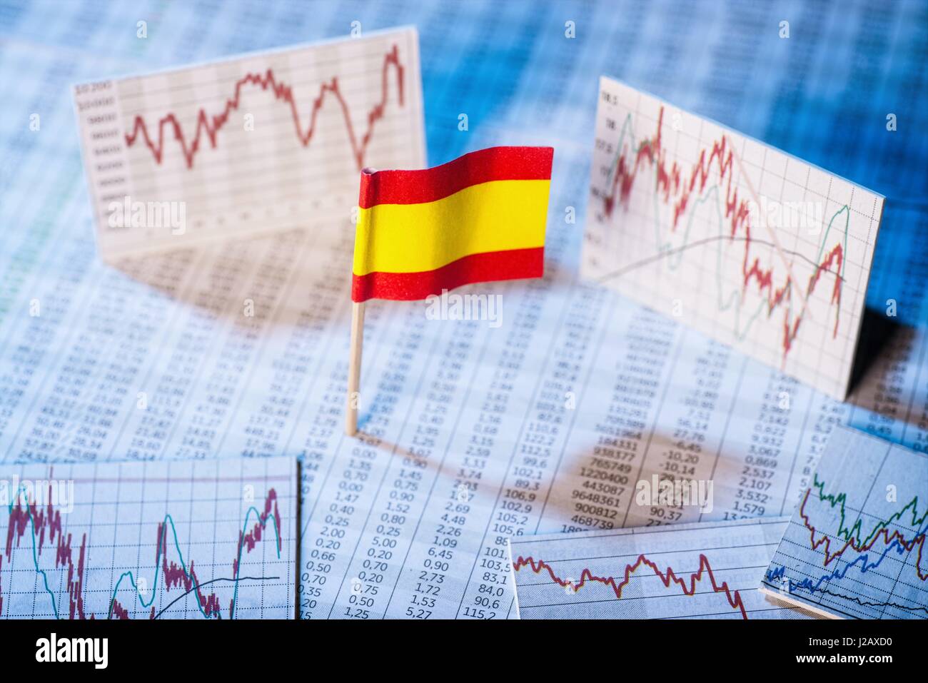 Spanish flag with rate tables and graphs for economic development ...