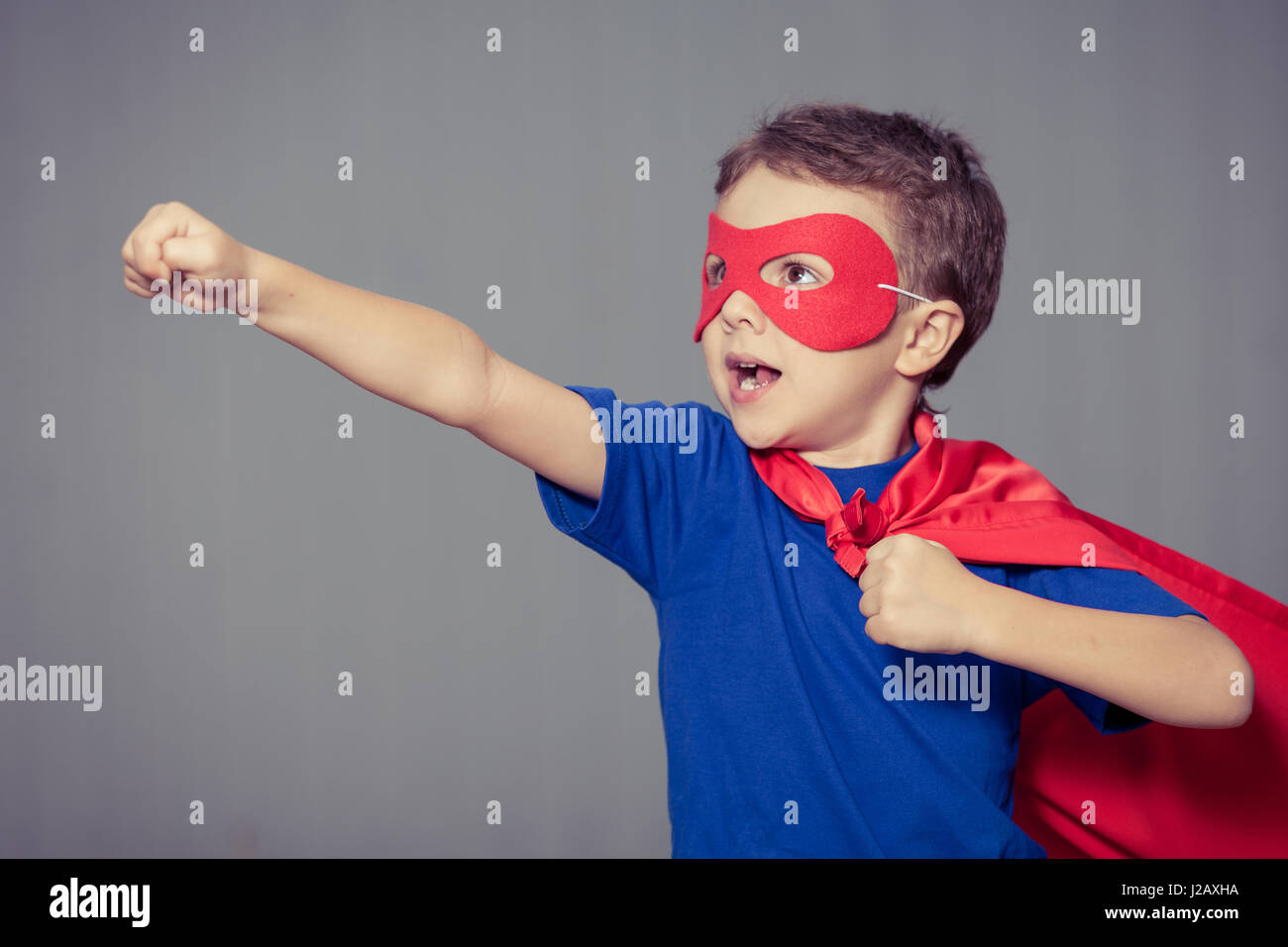 Happy little child playing superhero. Kid having fun outdoors. Concept ...