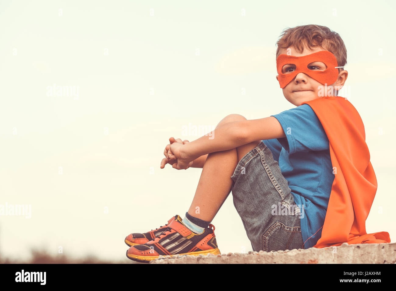 Happy little child playing superhero. Kid having fun outdoors. Concept ...