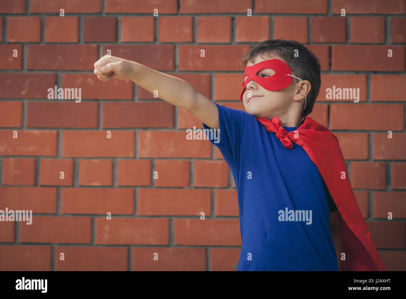 Happy little child playing superhero. Kid having fun outdoors. Concept ...