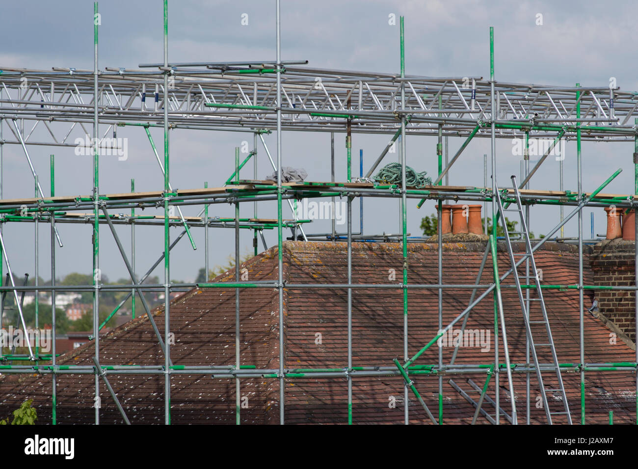 Scaffolding canopy erected over domestic house roof in London suburbs ...
