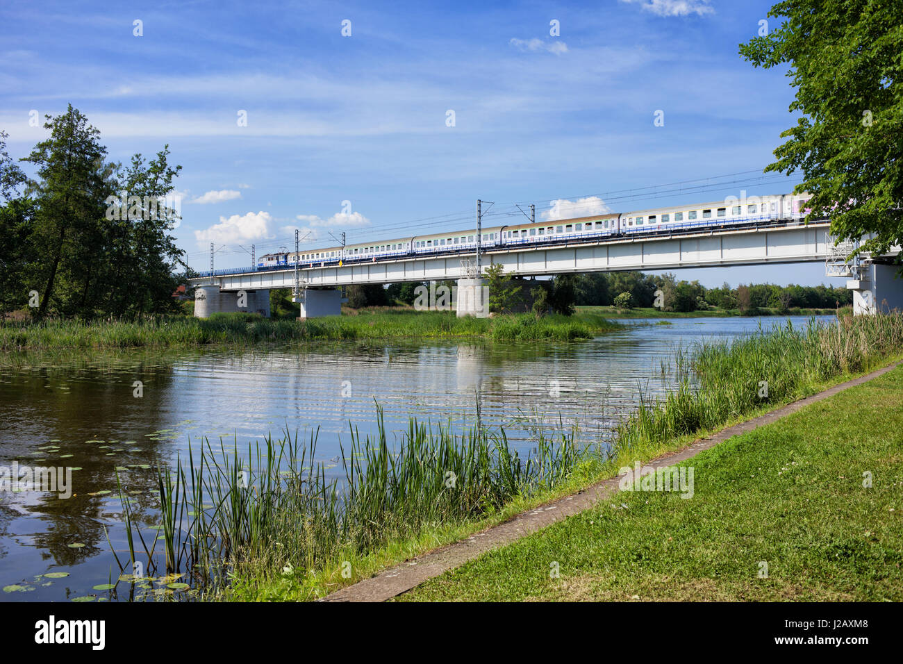 Nogat River with train on railway bridge in Malbork, Pomerania, Poland ...